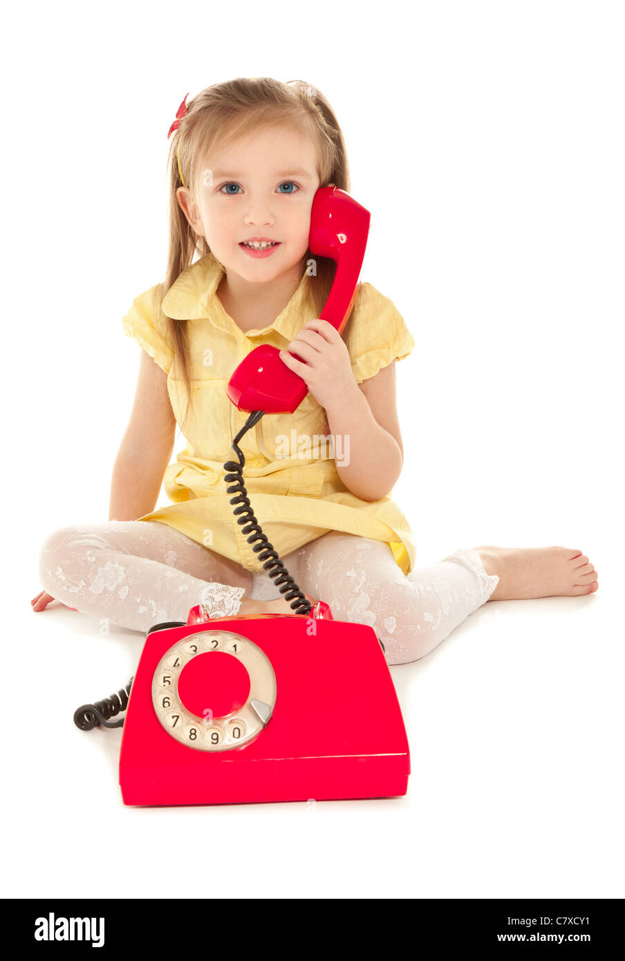 Little girl with old red phone sitting on the floor Stock Photo - Alamy