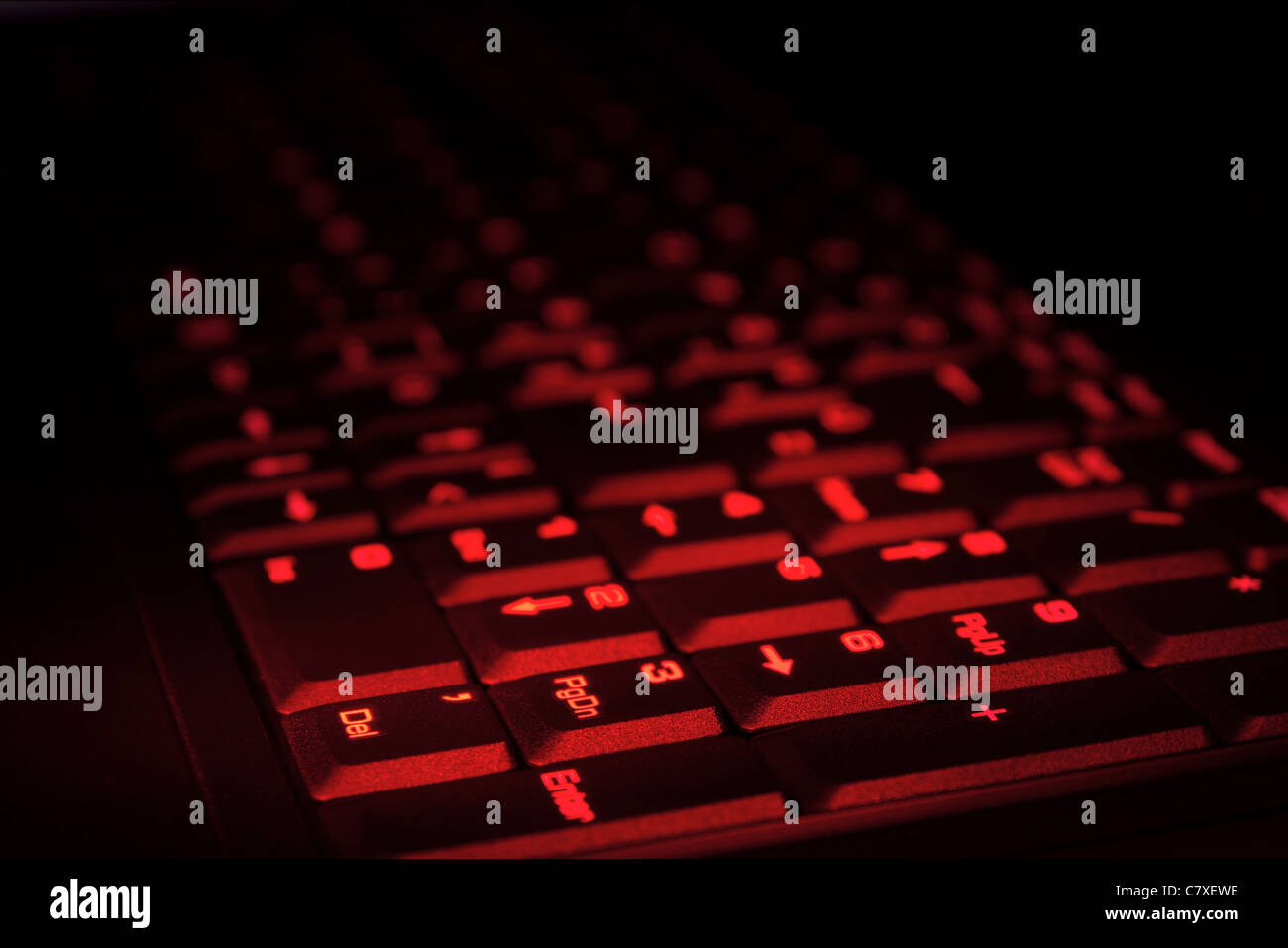 keyboard in the dark glowing in red Stock Photo - Alamy