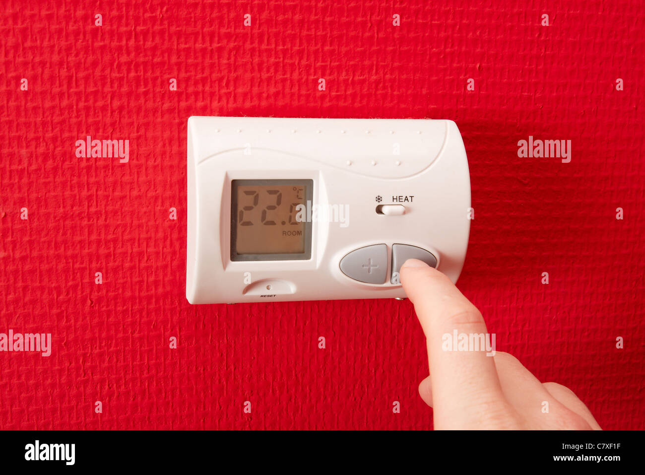 Adjusting the temperature on the thermostat Stock Photo - Alamy