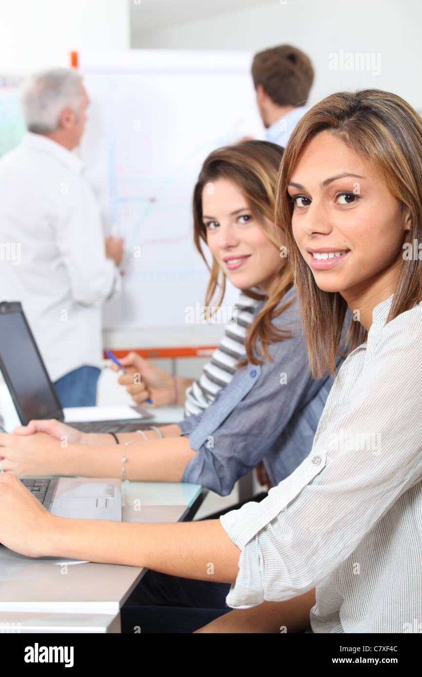 Young women smiling in classroom Stock Photo - Alamy