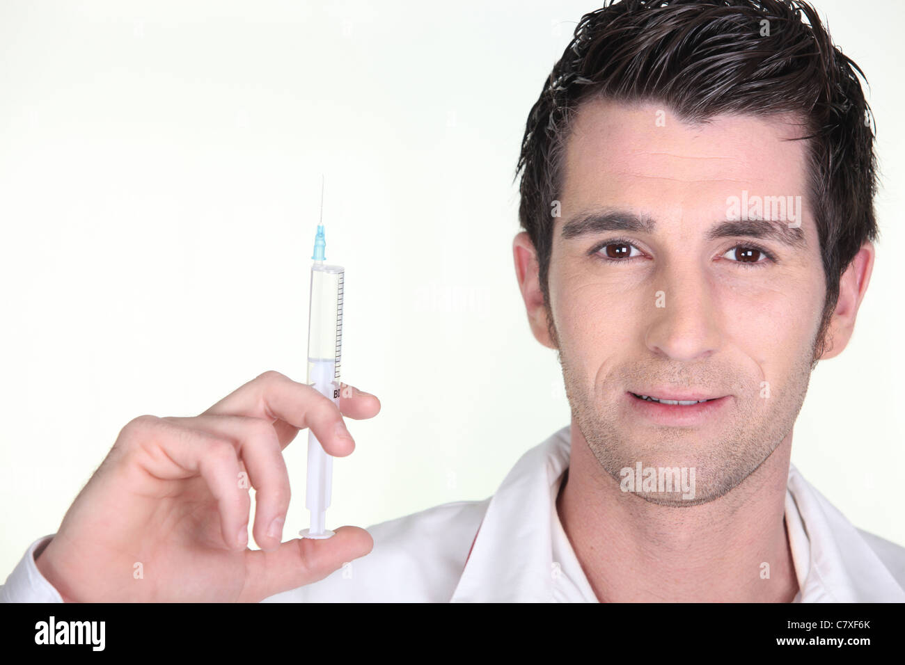 Doctor holding up an injection Stock Photo - Alamy