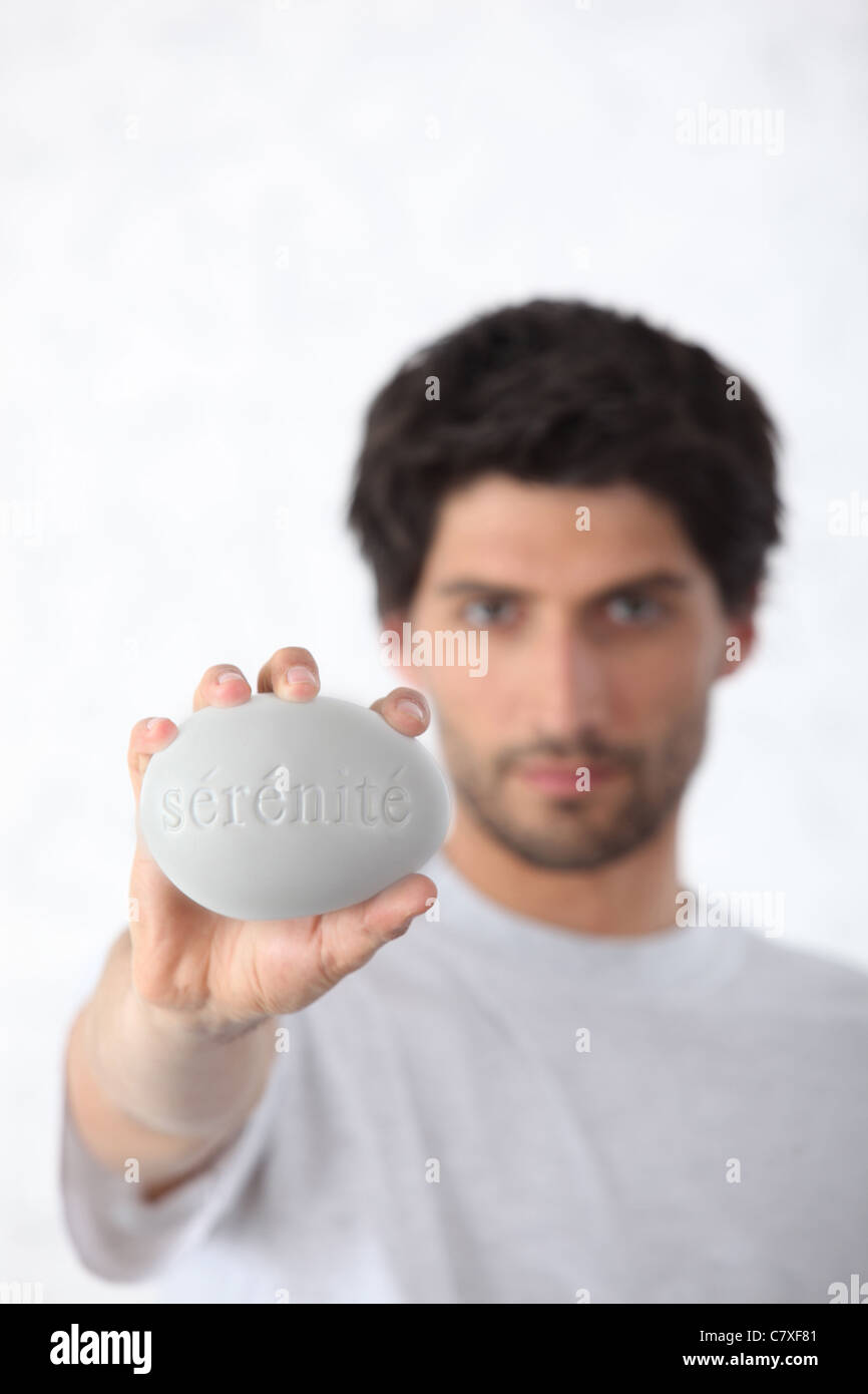 Man holding a bar of soap Stock Photo - Alamy