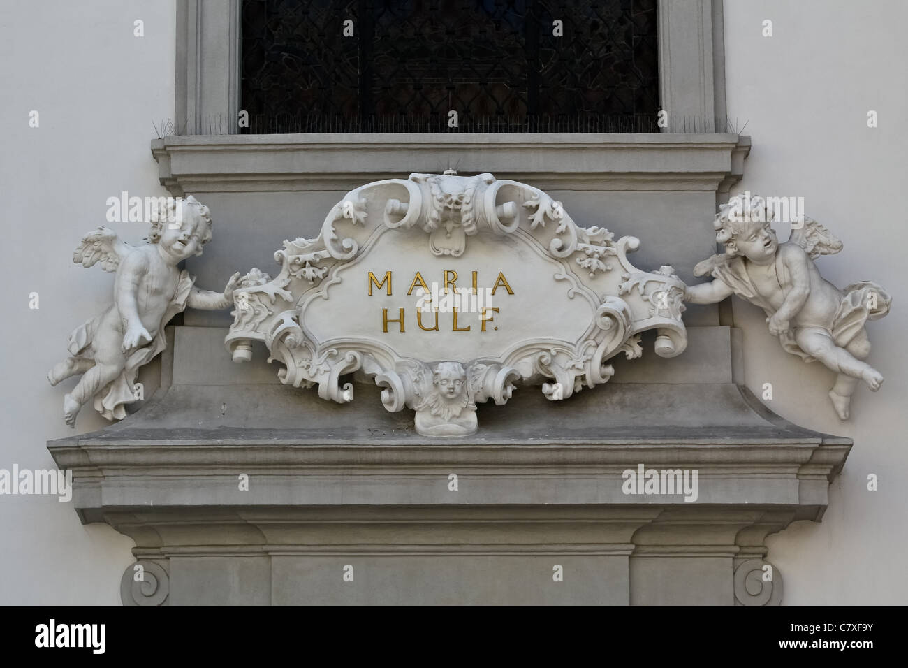 A baroque shield held by angels on a church in the city of Vienna ...