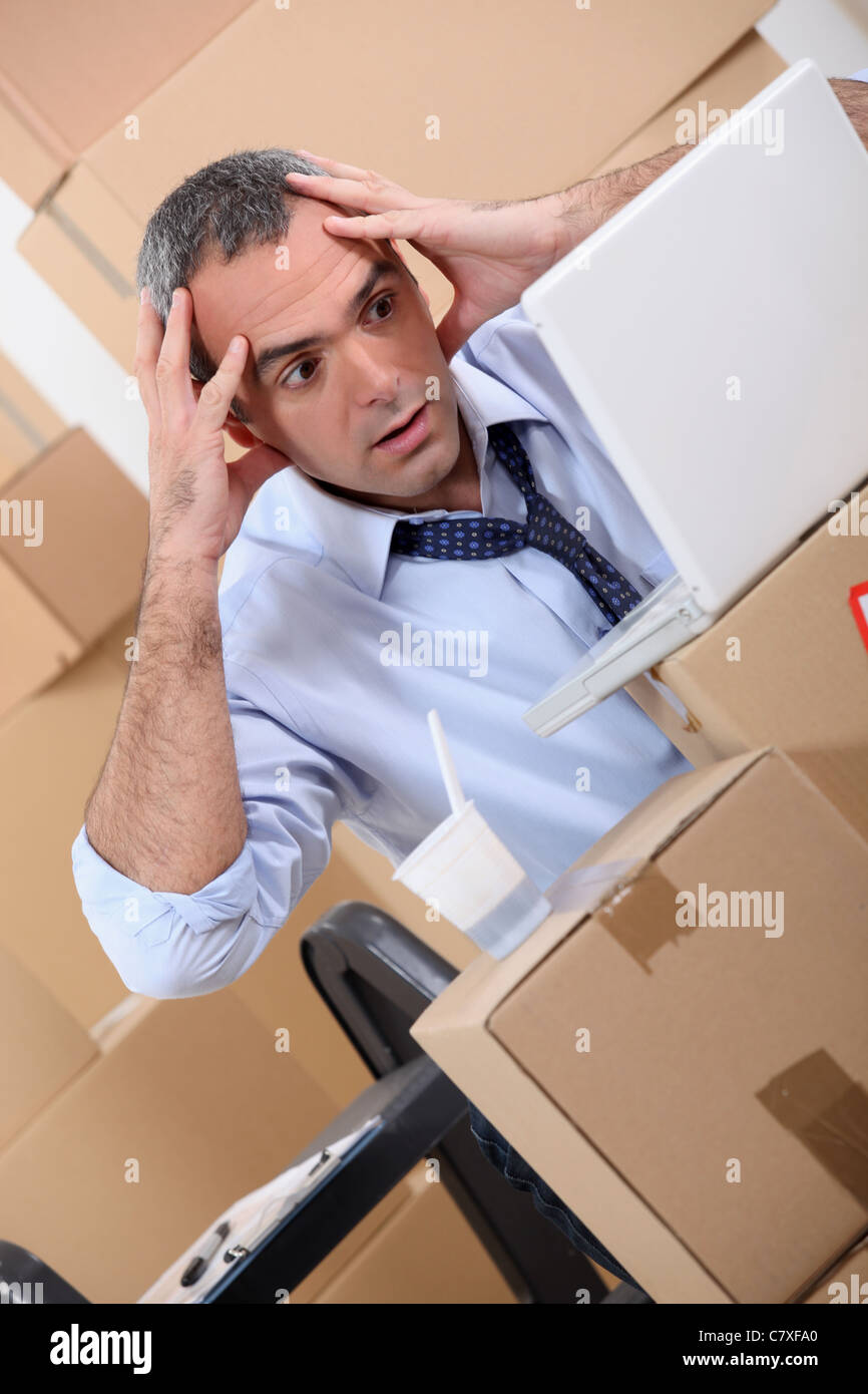 Man surrounded by boxes Stock Photo - Alamy