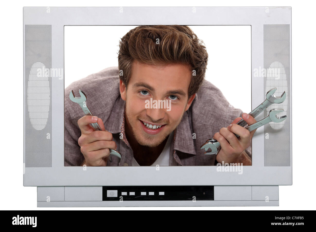 Young man with spanners poking his head through a mock up TV set Stock ...