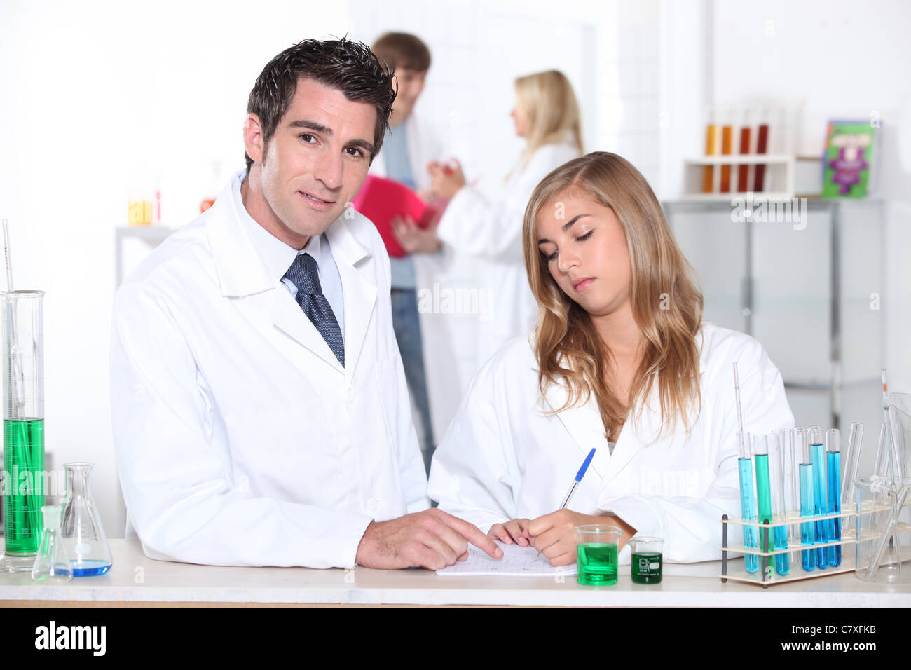 Student and teacher in chemistry class Stock Photo - Alamy