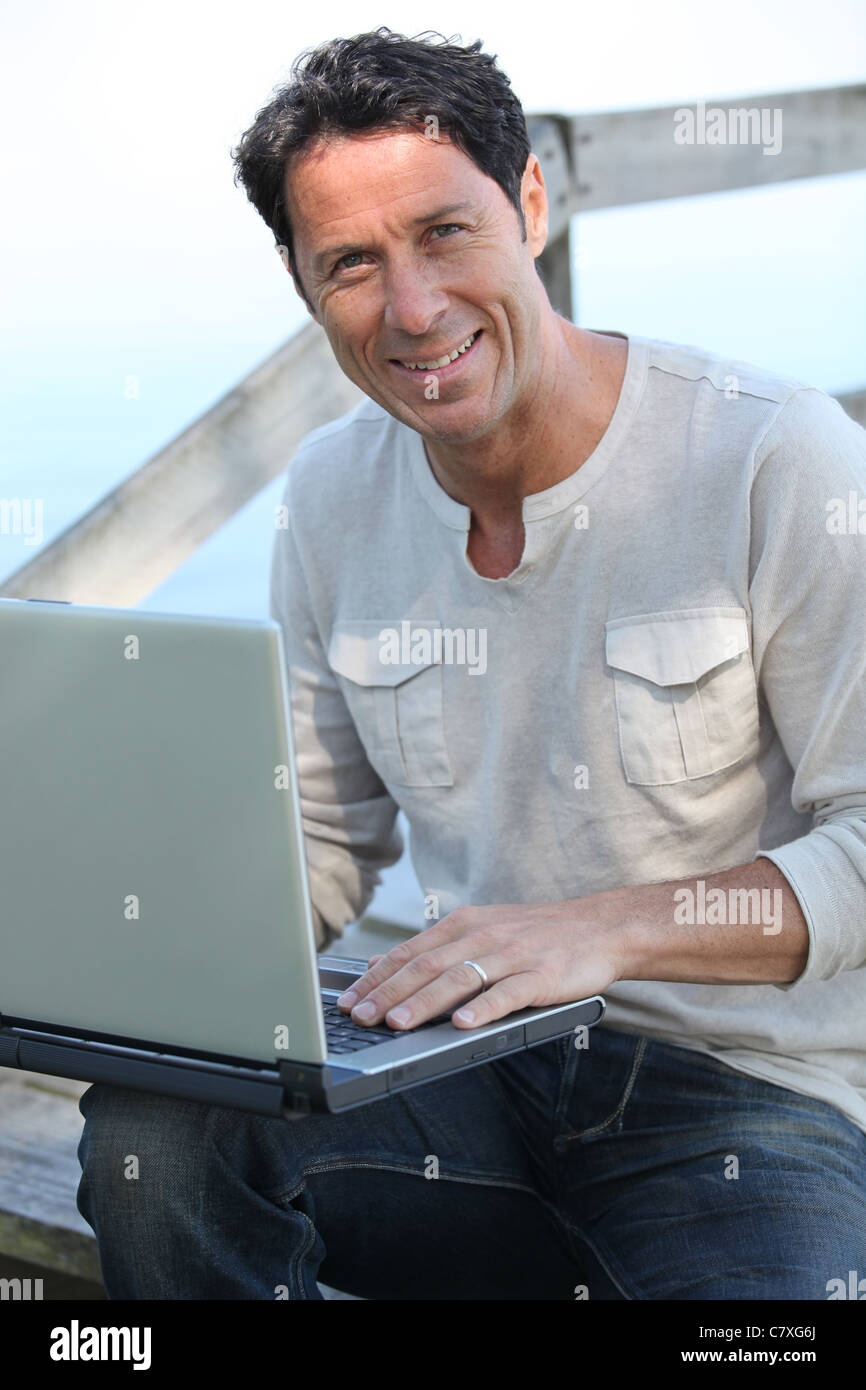 Man on laptop outside Stock Photo - Alamy