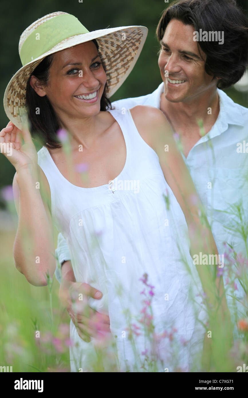 Couple relaxing in field Stock Photo - Alamy