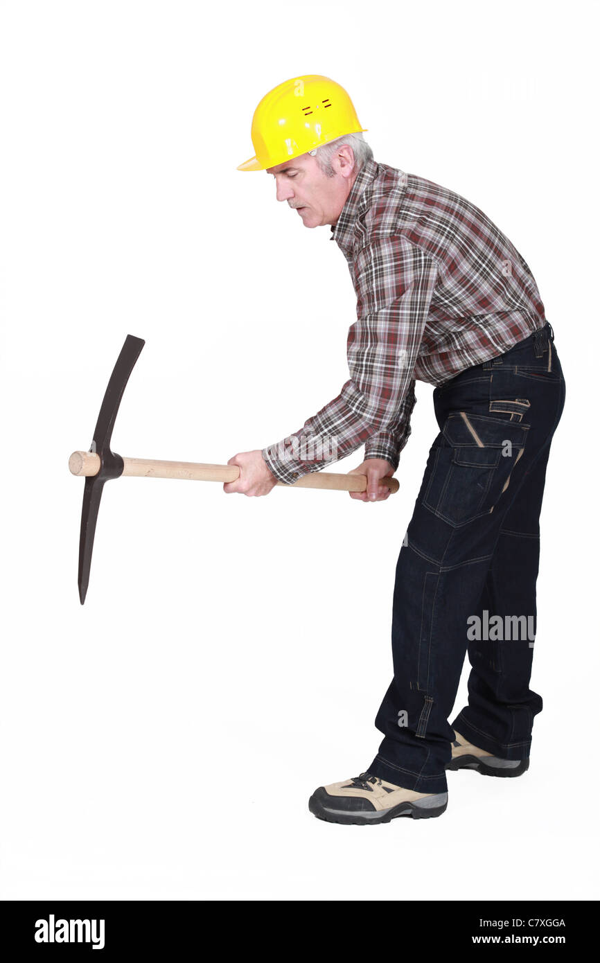 A mature construction worker using a pickaxe Stock Photo - Alamy
