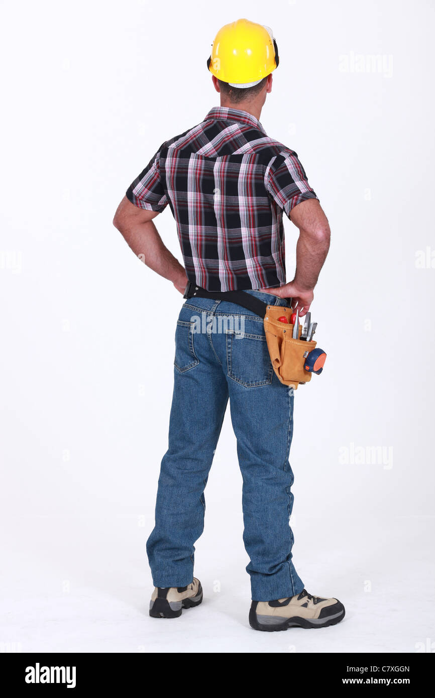 Laborer standing on white background, back-view Stock Photo - Alamy