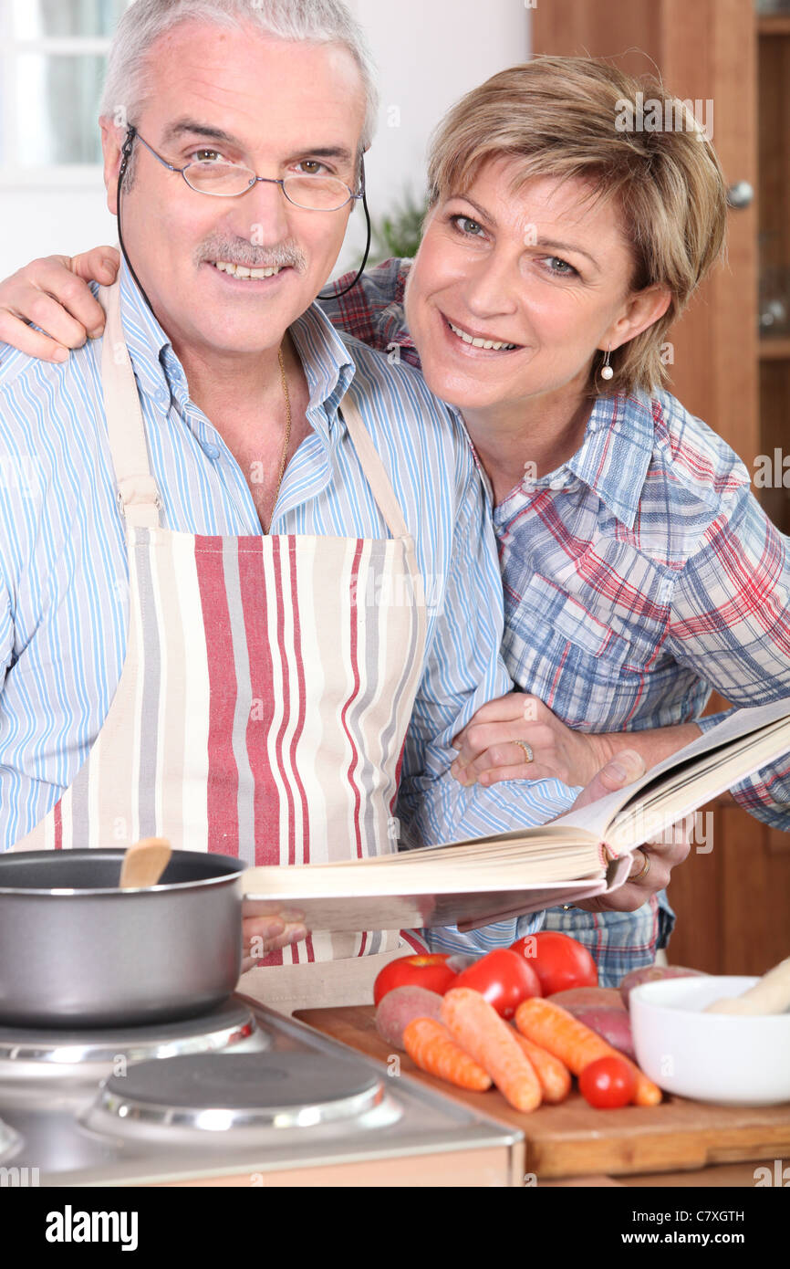 Husband looking at a cookbook Stock Photo - Alamy