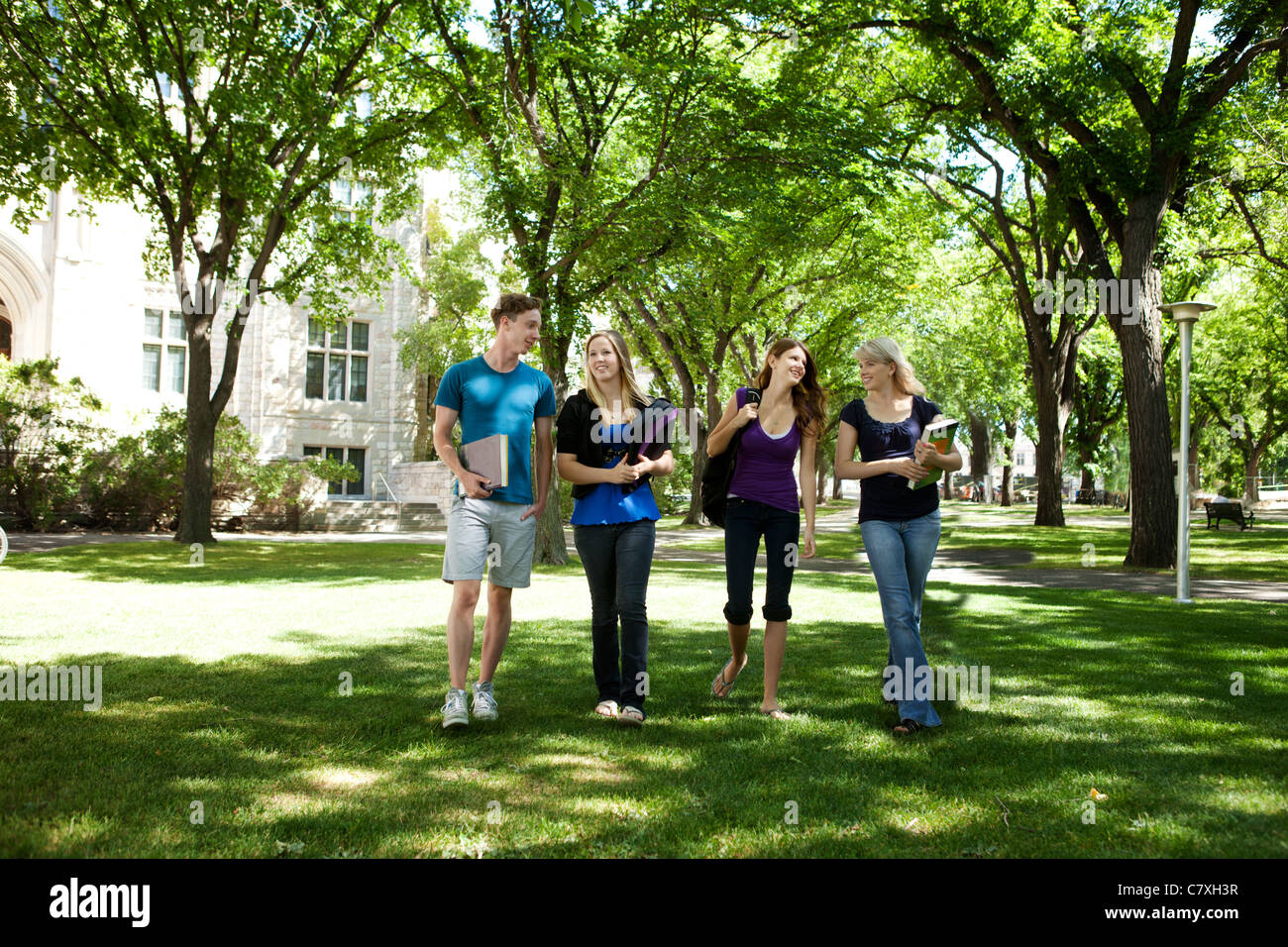 Students walking through campus visiting Stock Photo - Alamy