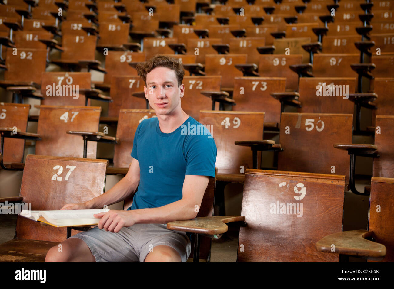 Portrait of a young university student sitting in a lecture hall Stock ...