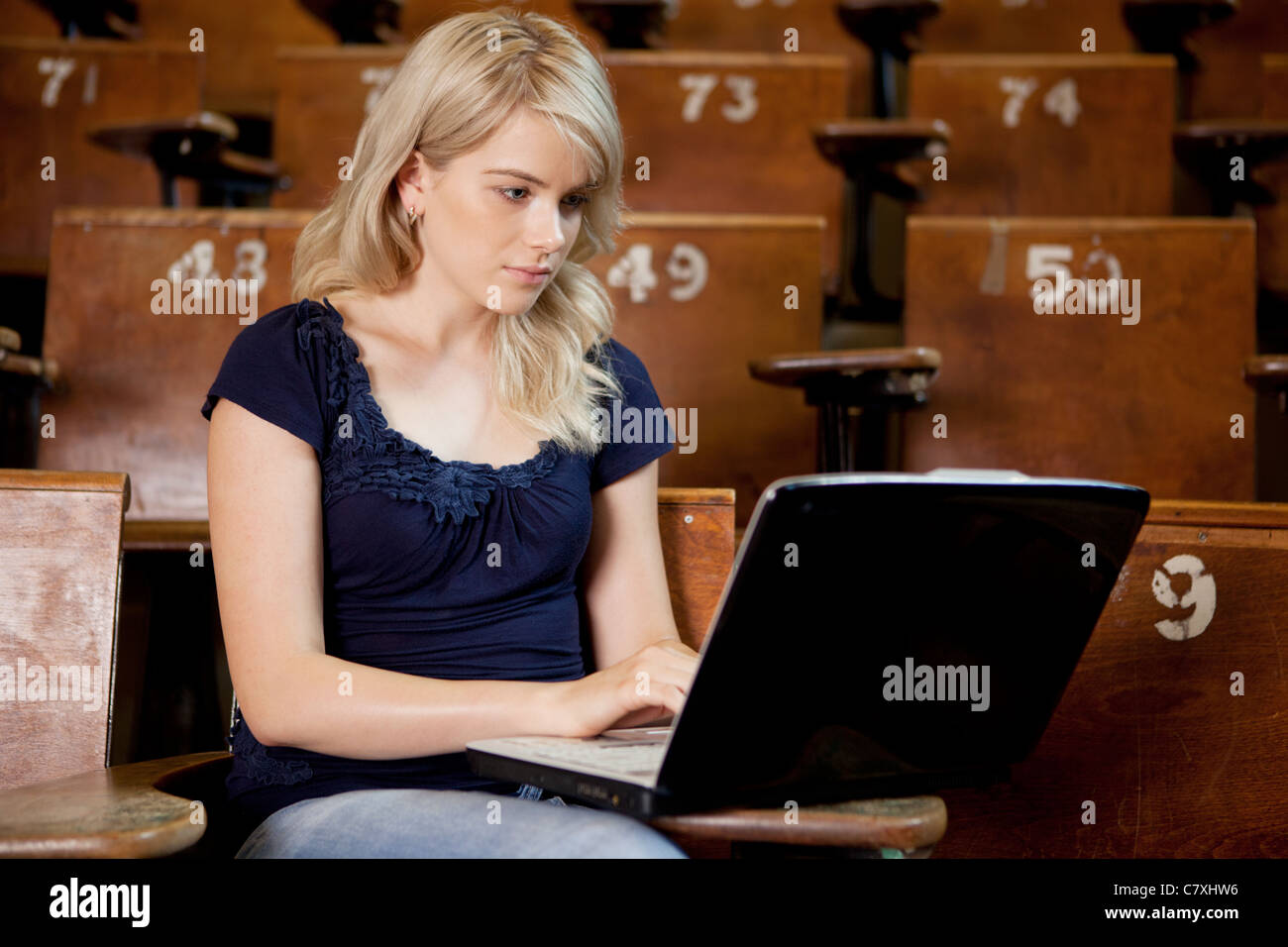 Pretty young university girl taking notes on a laptop computer Stock ...