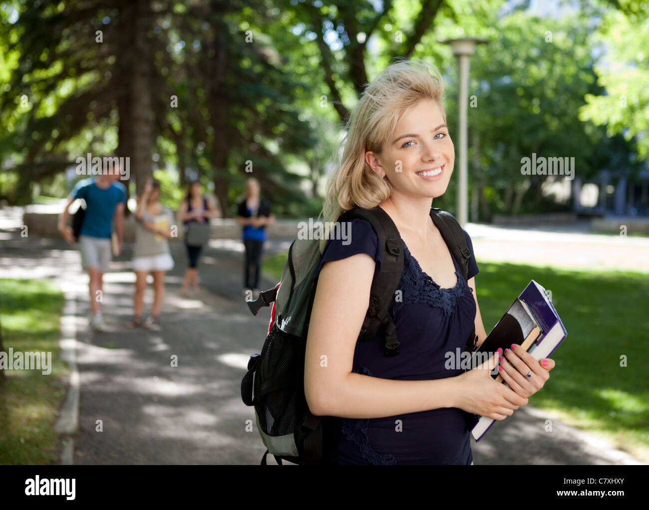 Portrait of a happy university girl walking to class outdoors Stock ...