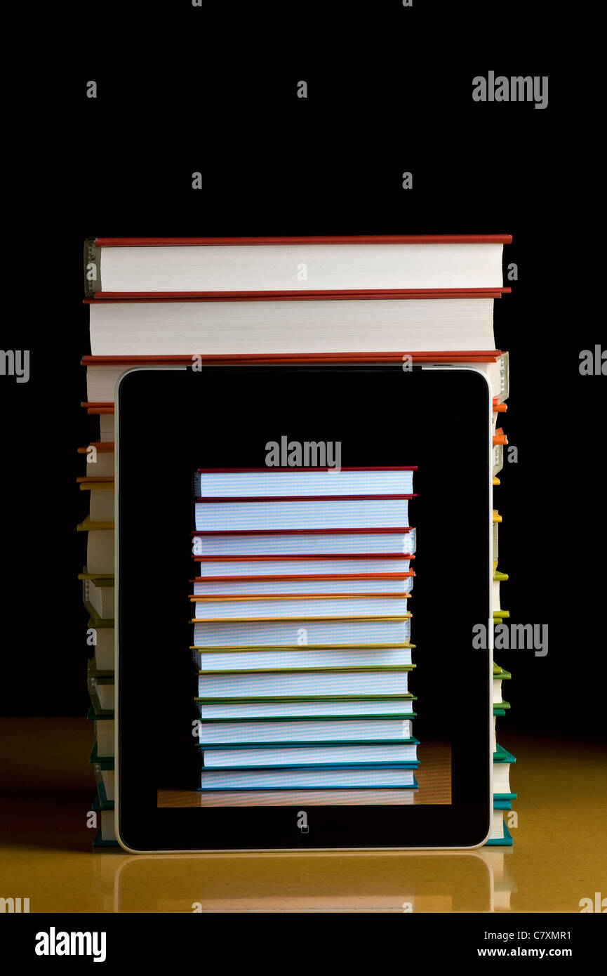 Ipad and paper books Stock Photo - Alamy