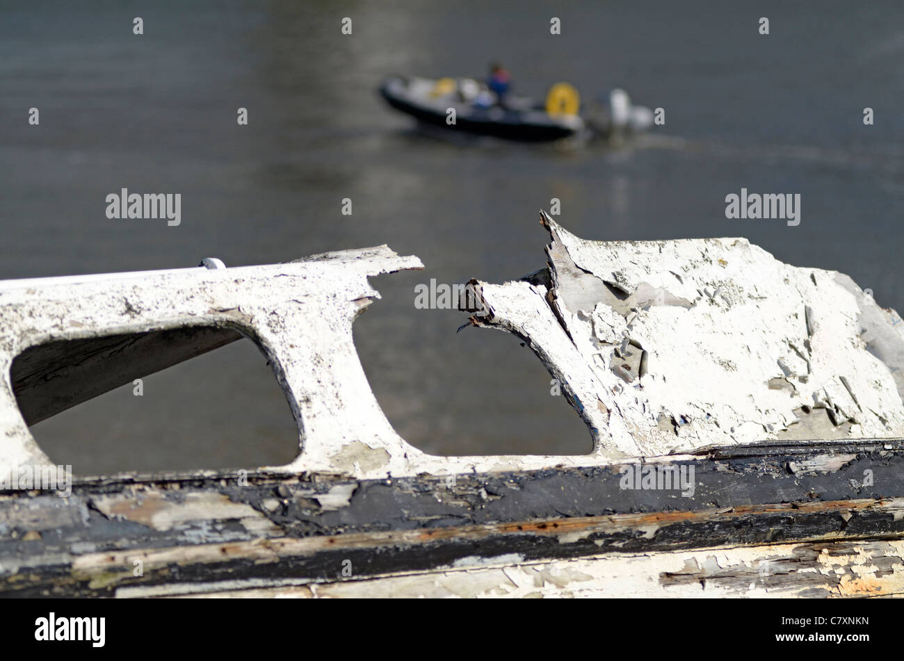 Speed boat launch with old wreck in foreground Stock Photo - Alamy