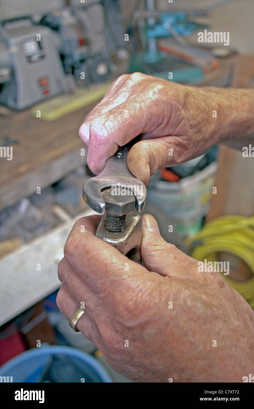 Engineer hands adjusting a bolt with a spanner close up Stock Photo - Alamy