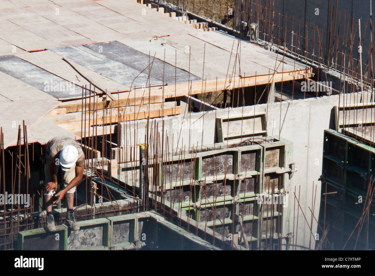 Construction workers build housing in Giloh in spite of Western ...
