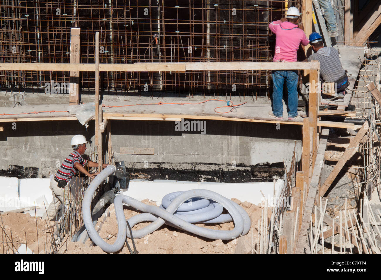 Construction workers build housing in Giloh in spite of Western ...