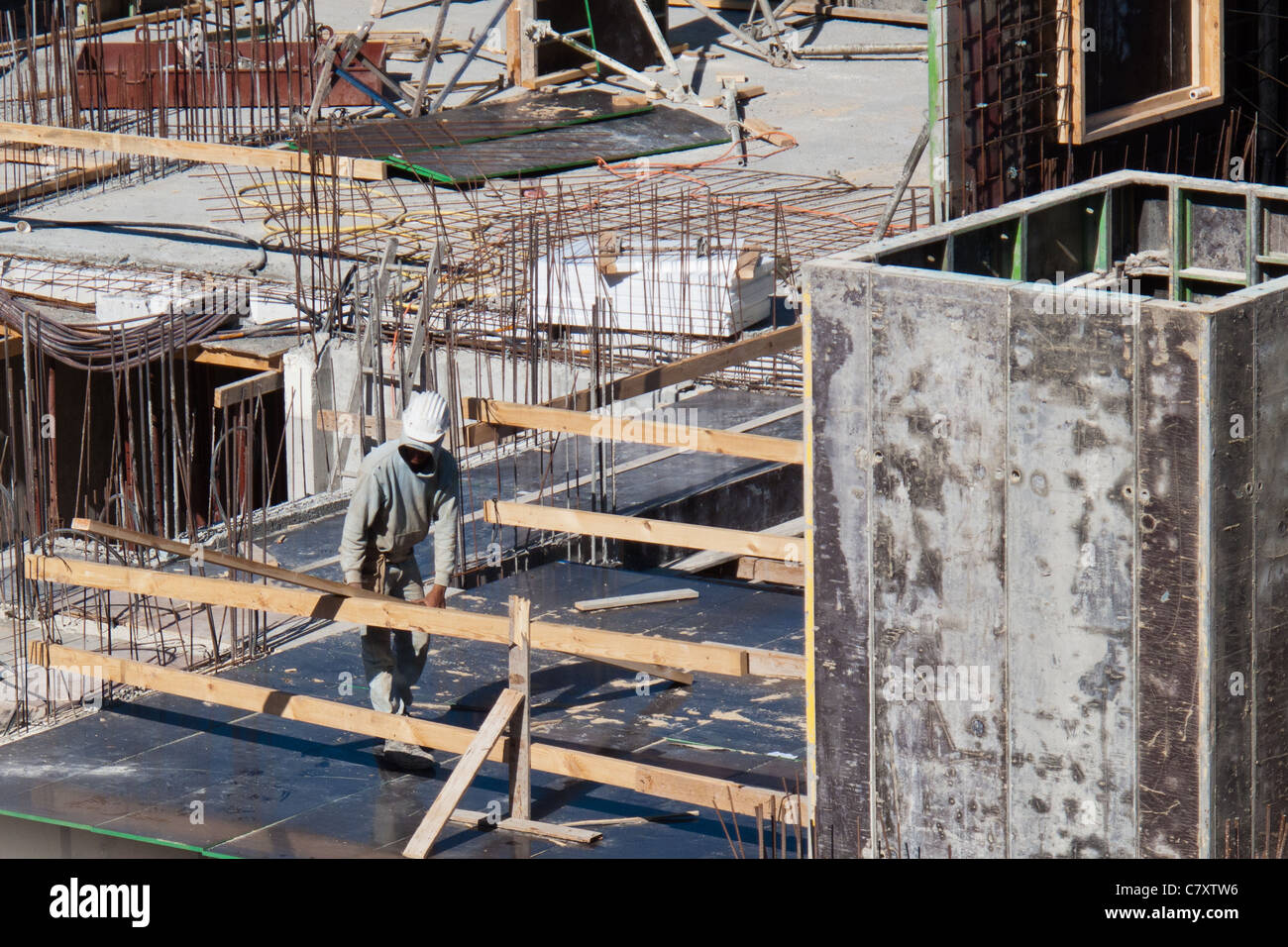 Construction workers build housing in Giloh in spite of Western ...