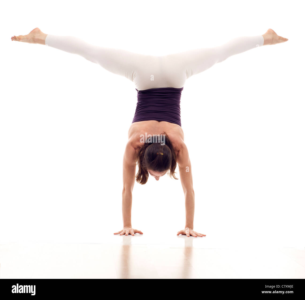 Dancer standing on hands, holding legs in air isolated over white ...