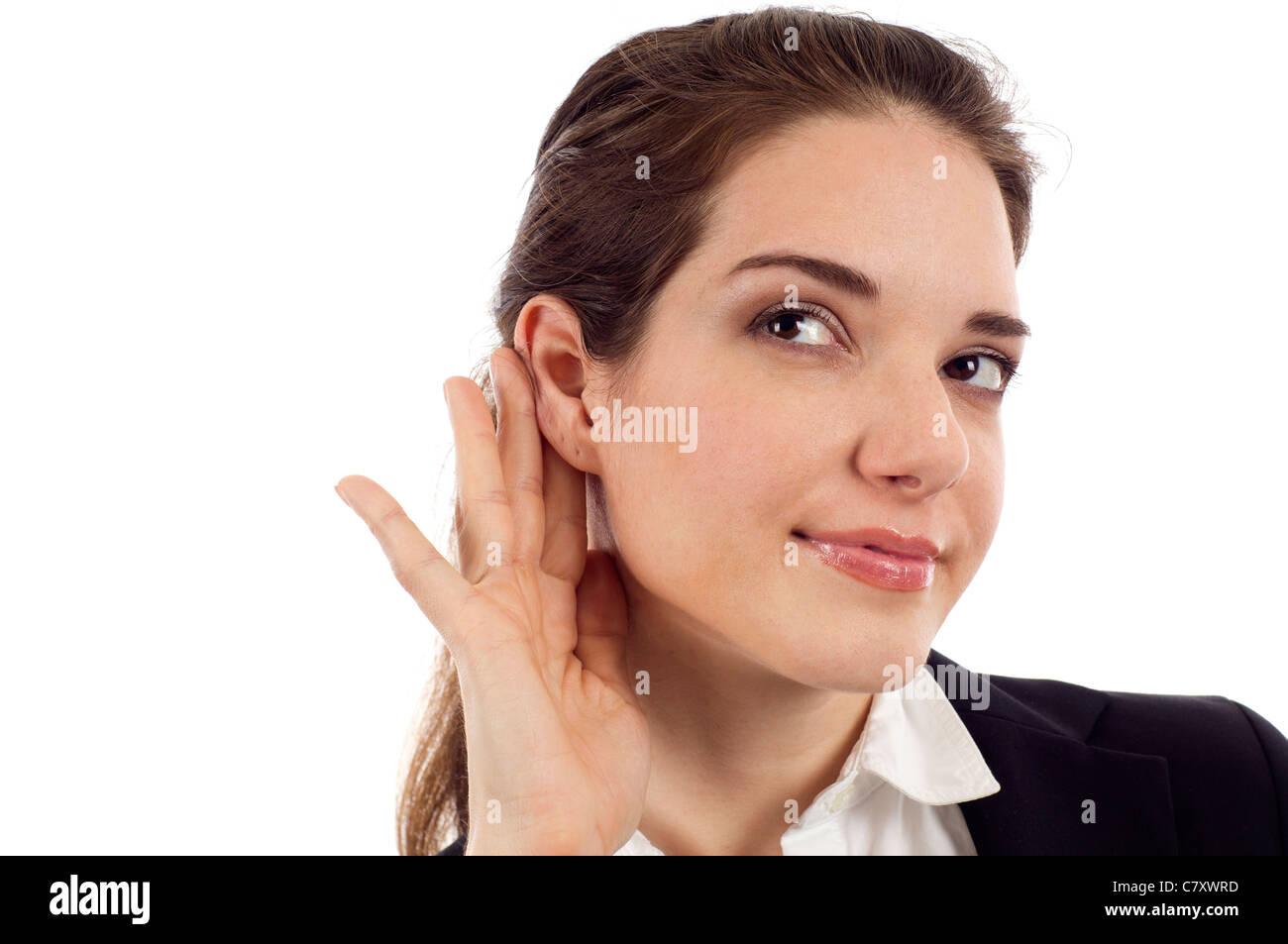 Woman listening with her hand on an ear isolated over white background ...