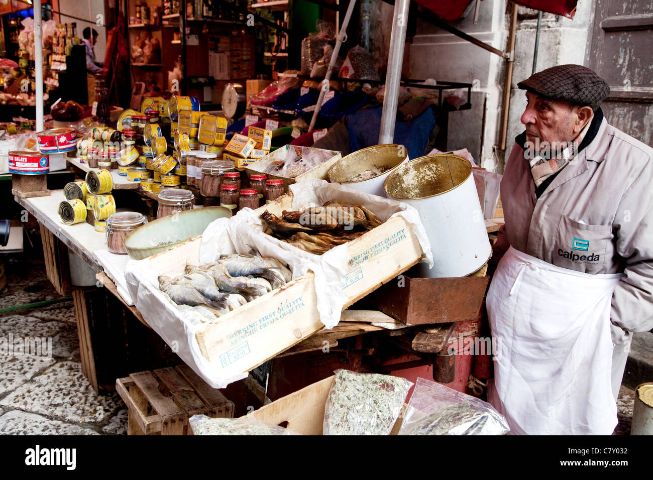 Old man at traditional fish shop selling seafood and dried fish at Capo ...