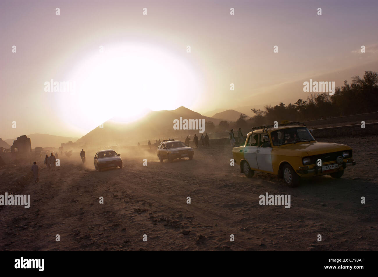 Taxis drive down a road on the outskirts of Kabul, Afghanistan ...
