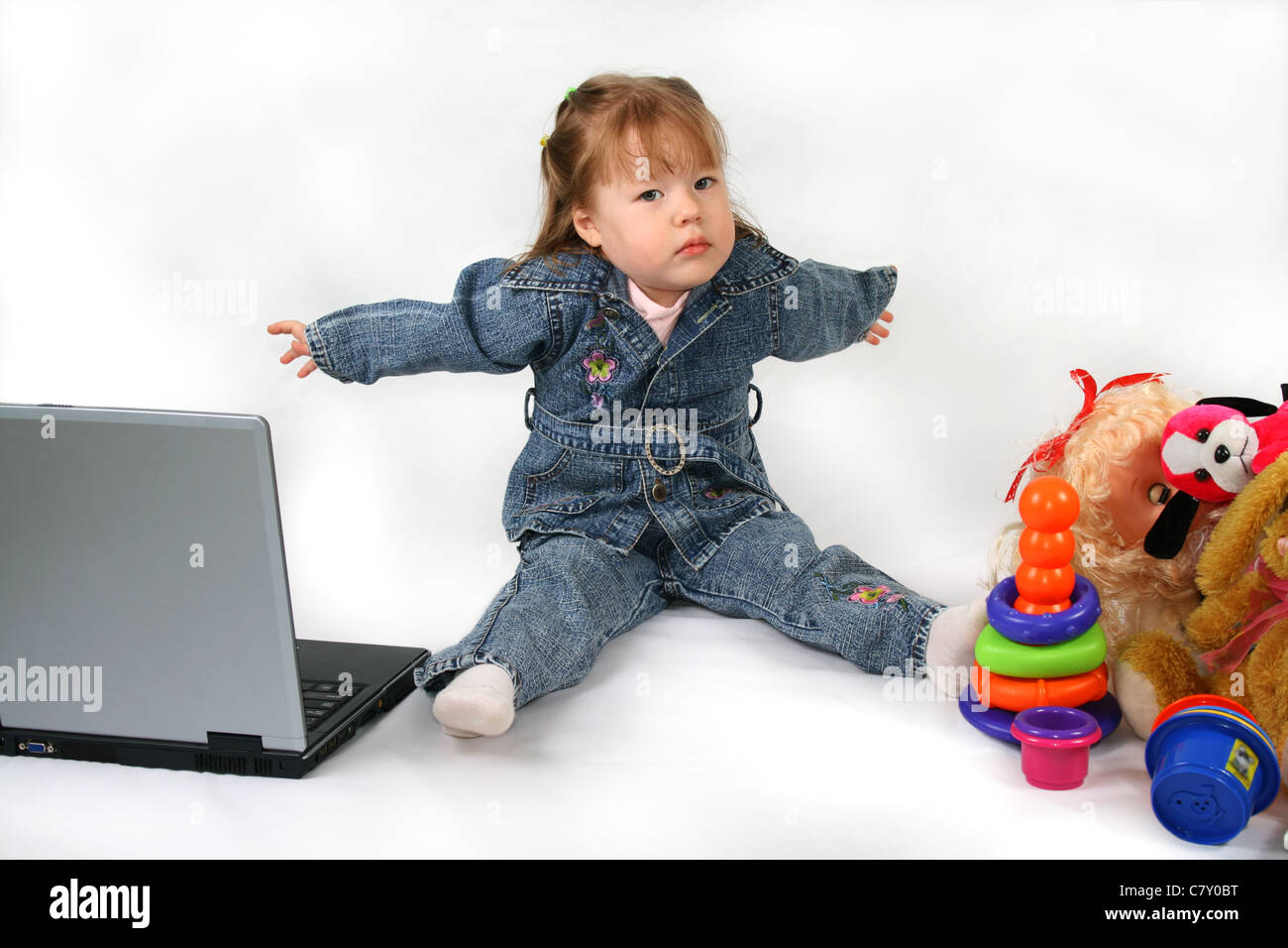 Child is not know which way to select. Computer or toys Stock Photo - Alamy