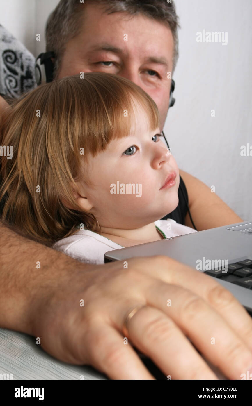 Thoughtful father and attentive daughter using Laptop Stock Photo - Alamy