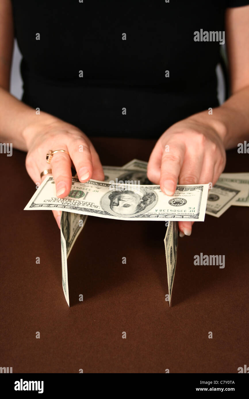 The unsteady house money in human hands Stock Photo - Alamy