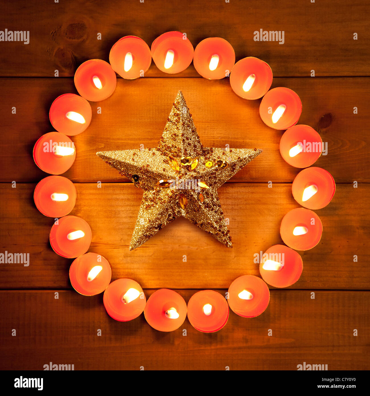 christmas candles circle over wood and golden star symbol Stock Photo ...