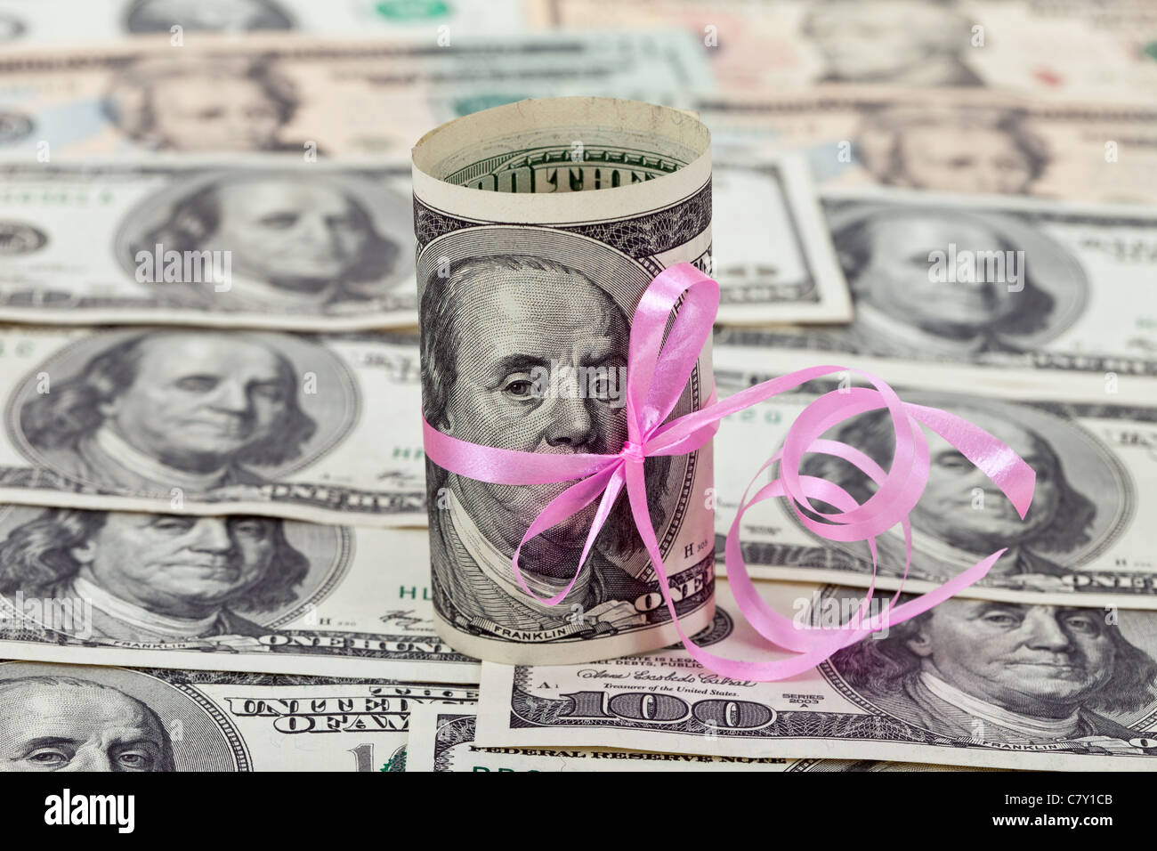 100 US dollar wrapped by ribbon on money background Stock Photo - Alamy