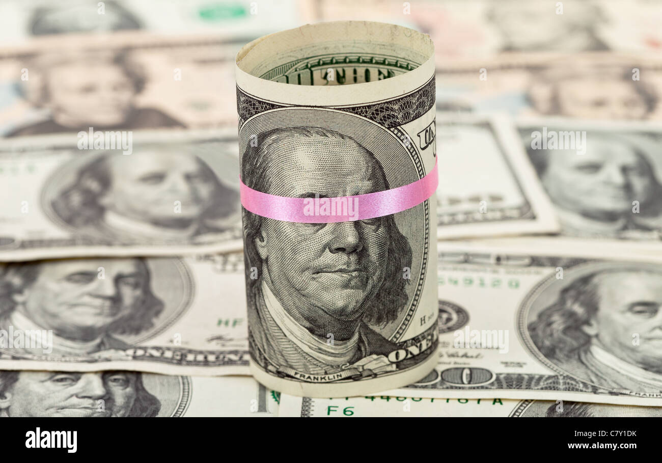 100 US dollar wrapped by ribbon on money background Stock Photo - Alamy