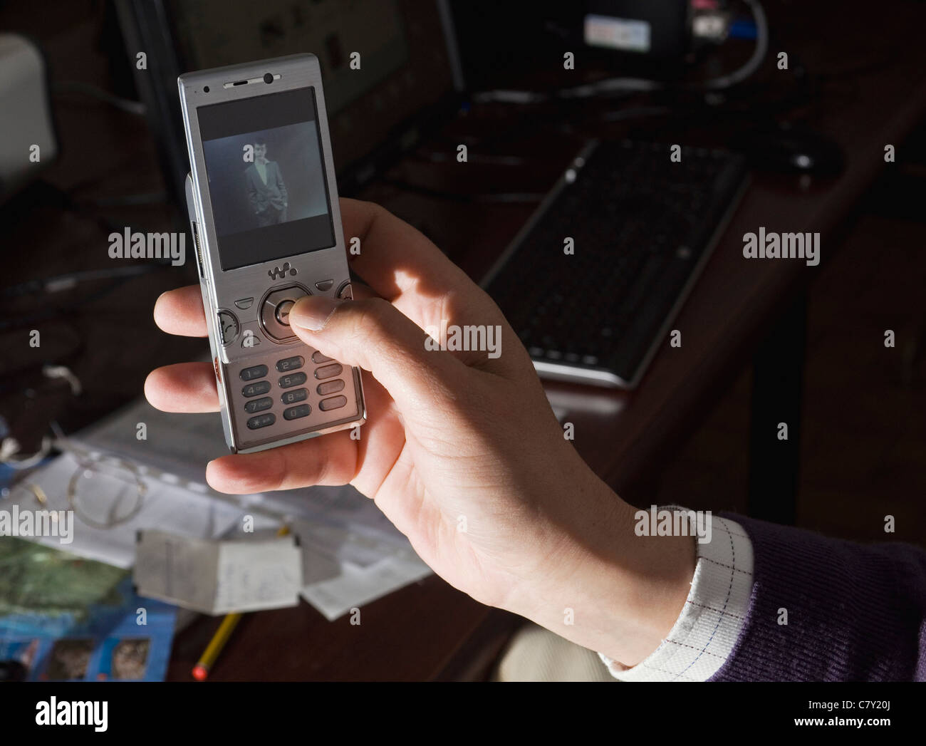 Male hand holding cellphone watching a picture Stock Photo - Alamy