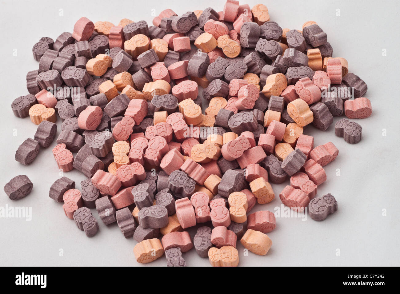 Assortment of animal vitamins spread across an off-white surface Stock ...