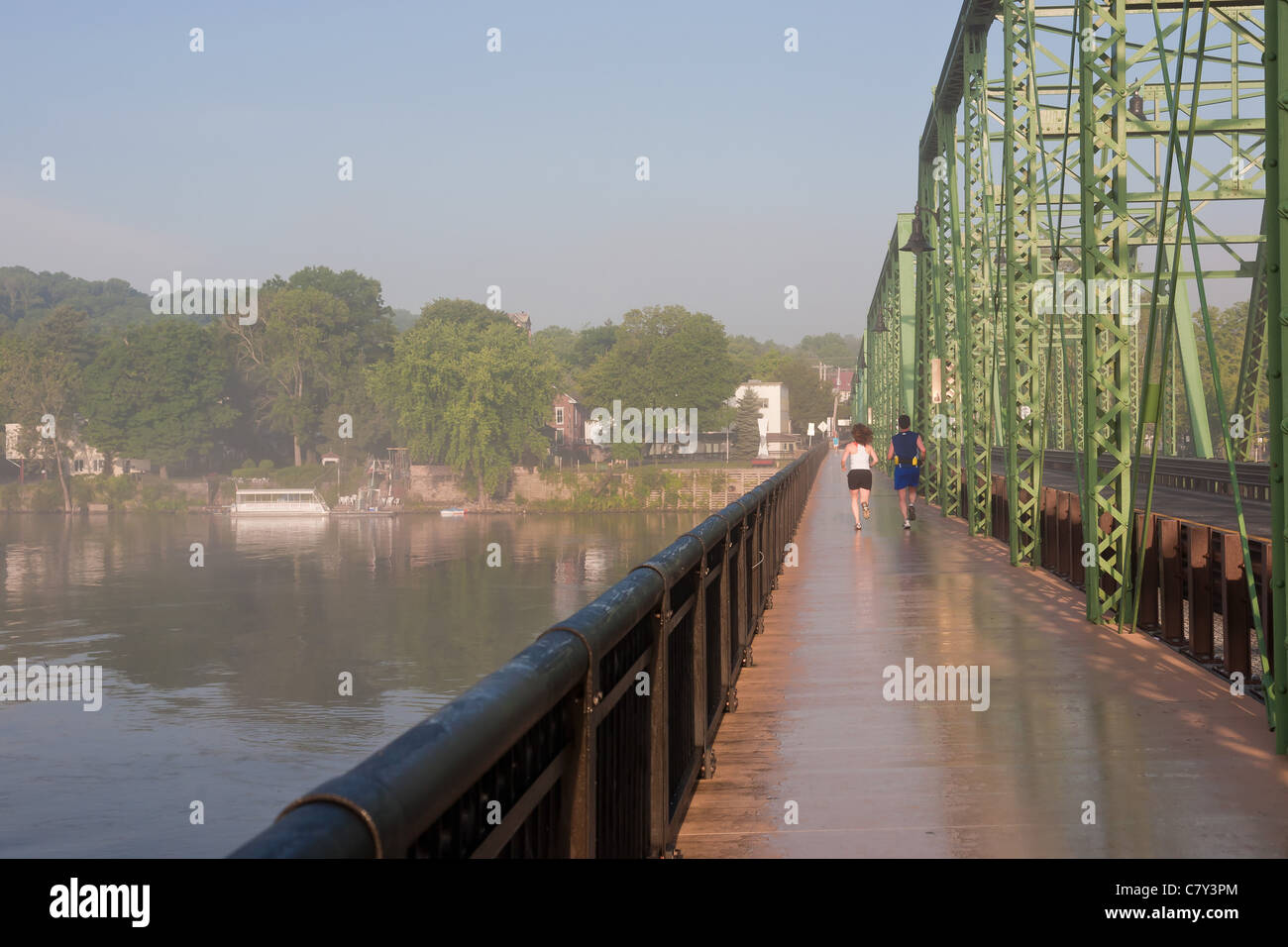 Two joggers running across the bridge connecting New Hope, Pennsylvania ...
