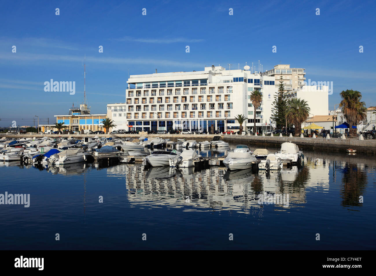 Boats float in the blue water of the marina at Faro, Portugal Stock ...