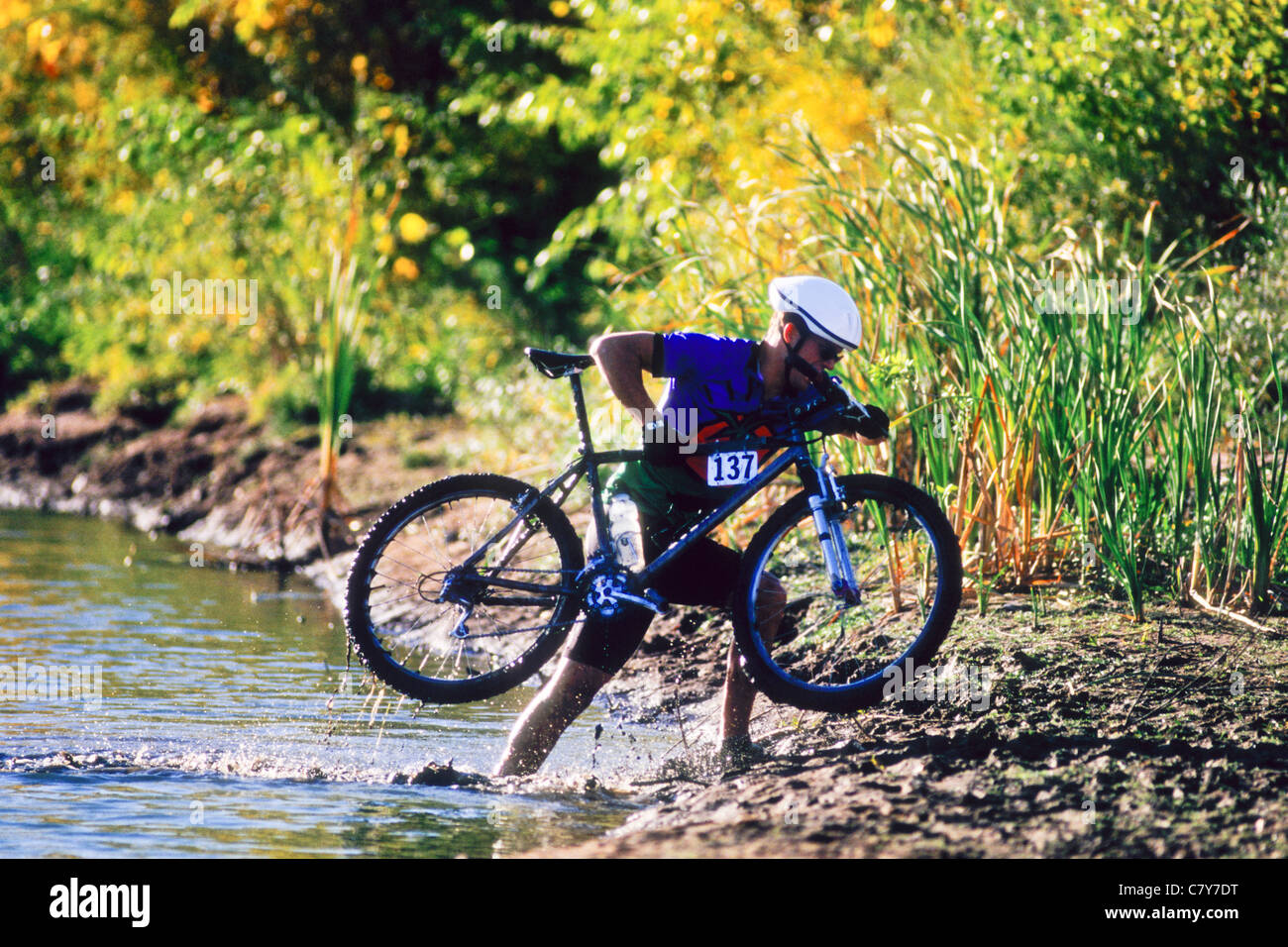 Man carrying mountain bike in river hi-res stock photography and images ...