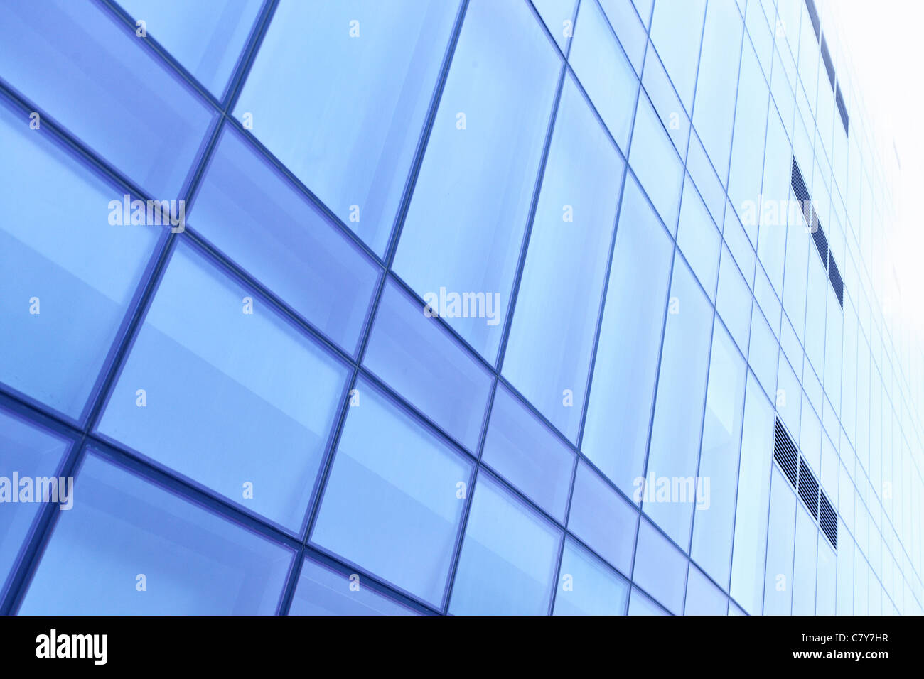 Windows of modern building toned in blue color Stock Photo - Alamy