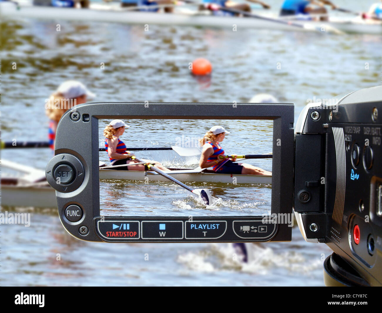 View through the camera on women rowers in a rowing boat pulling in ...