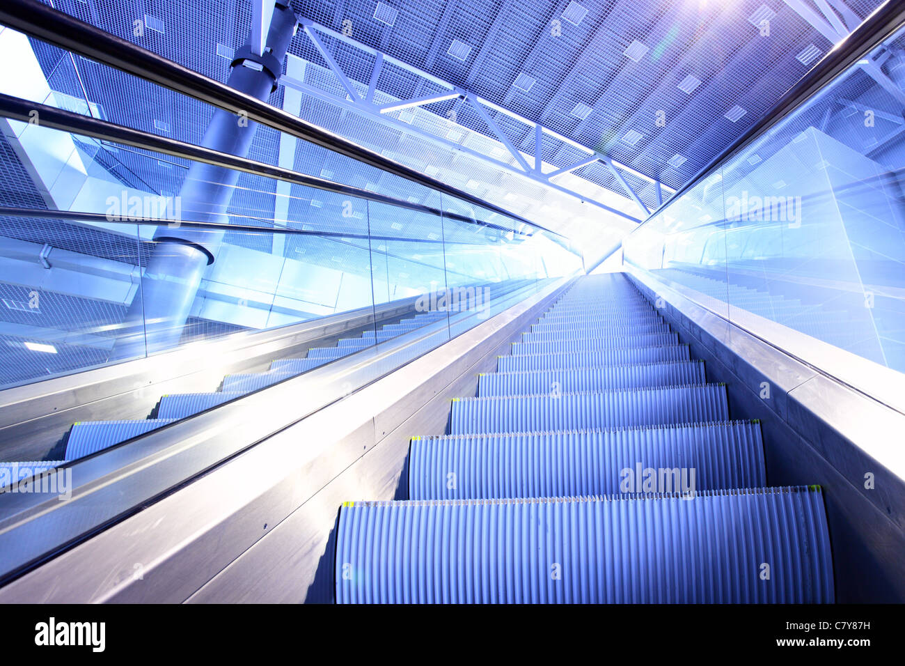 Perspective of escalator toned in blue color Stock Photo - Alamy