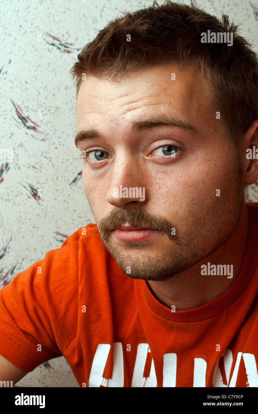 Young man with mustache in orange shirt Stock Photo - Alamy