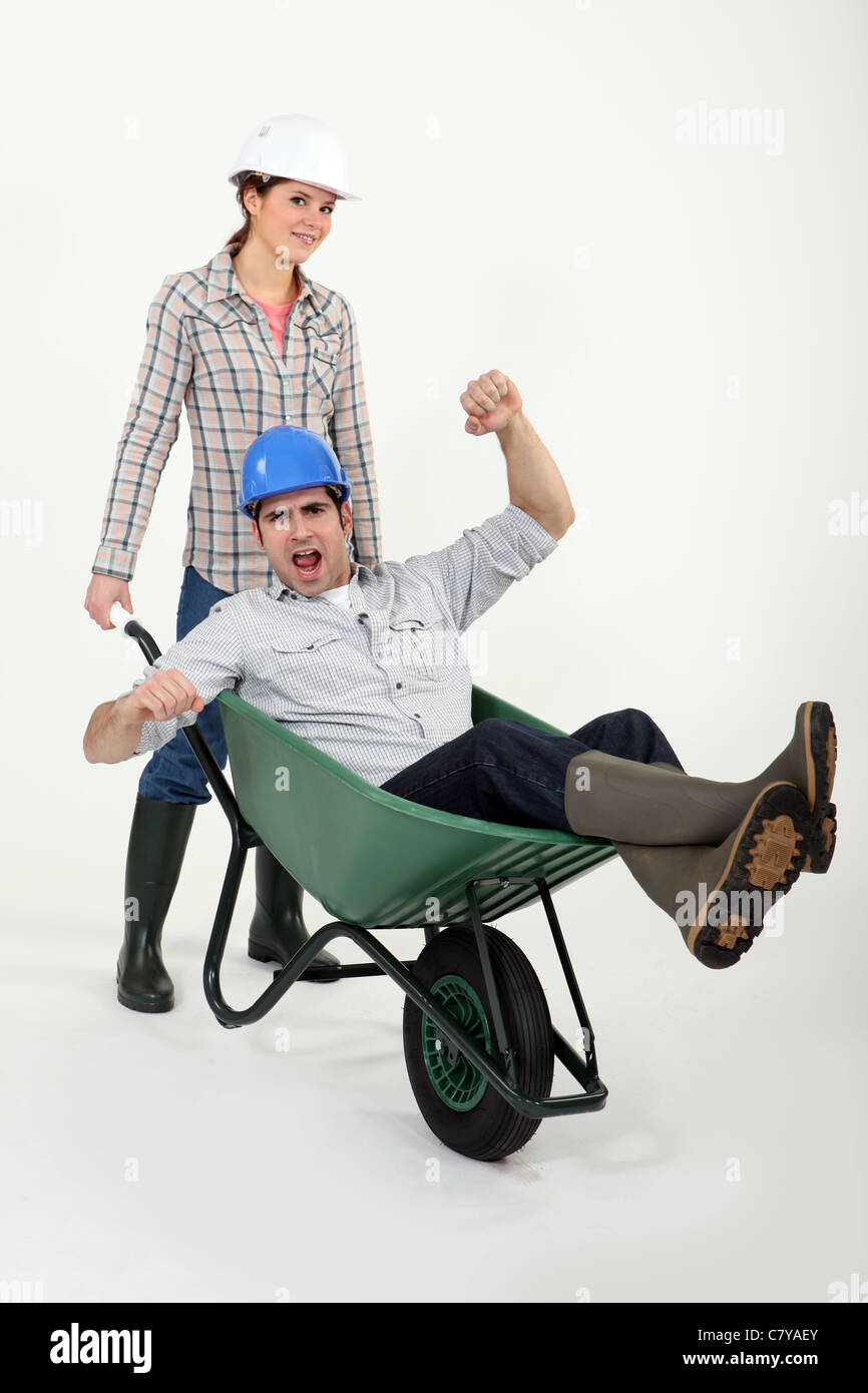 Workers with a wheelbarrow Stock Photo - Alamy