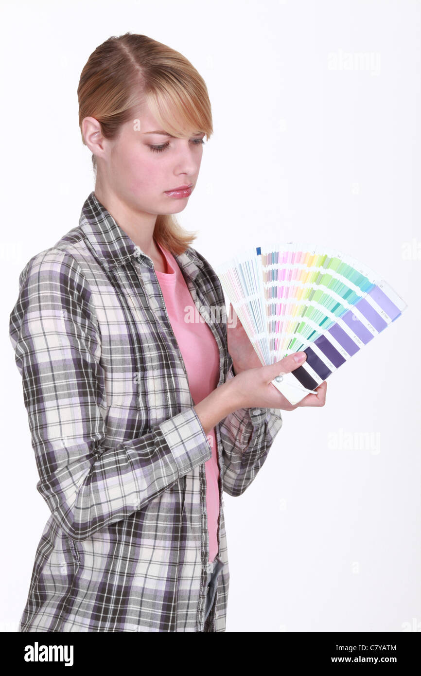 Woman holding up paint samples Stock Photo - Alamy