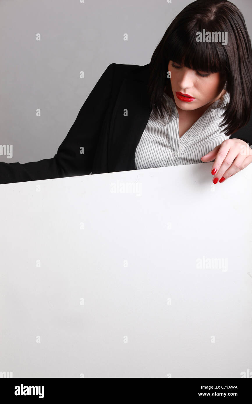 Elegant dark-haired woman carrying white sign Stock Photo - Alamy