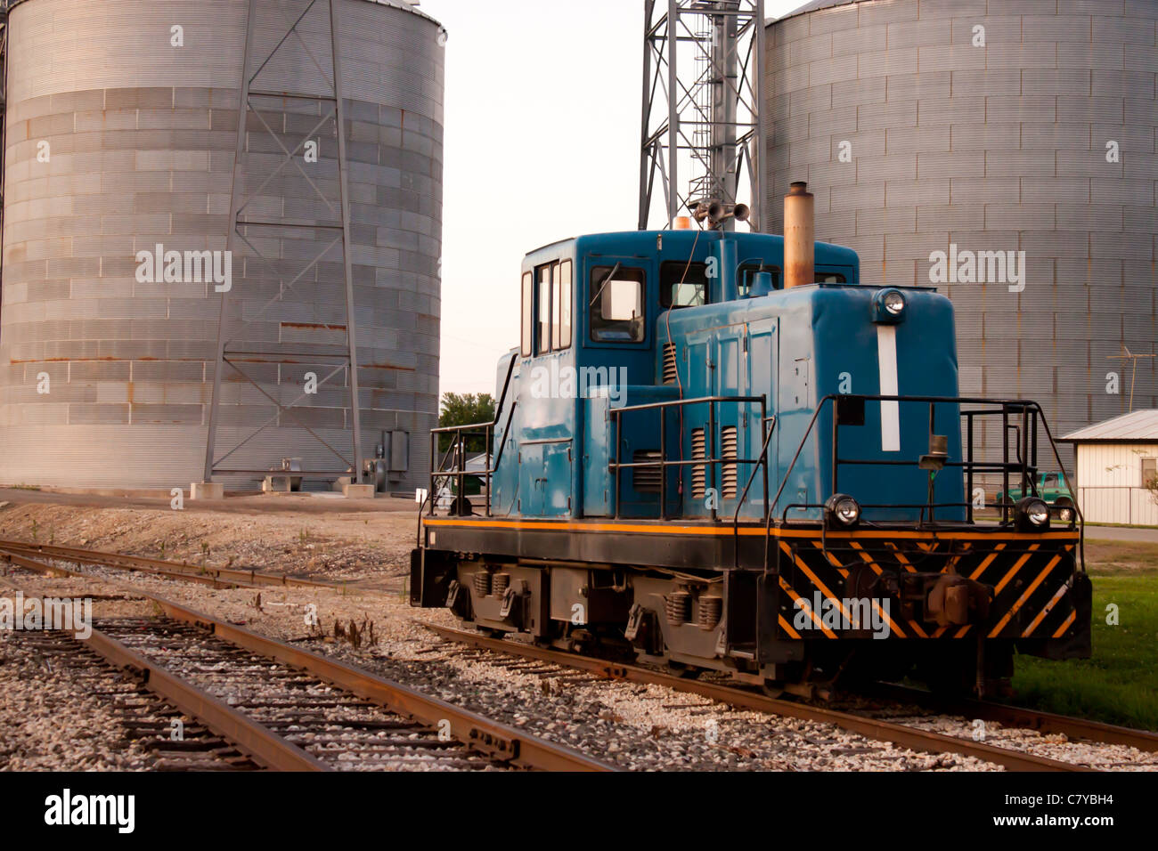 Train head car stopped on tracks in front of grain mill Stock Photo - Alamy