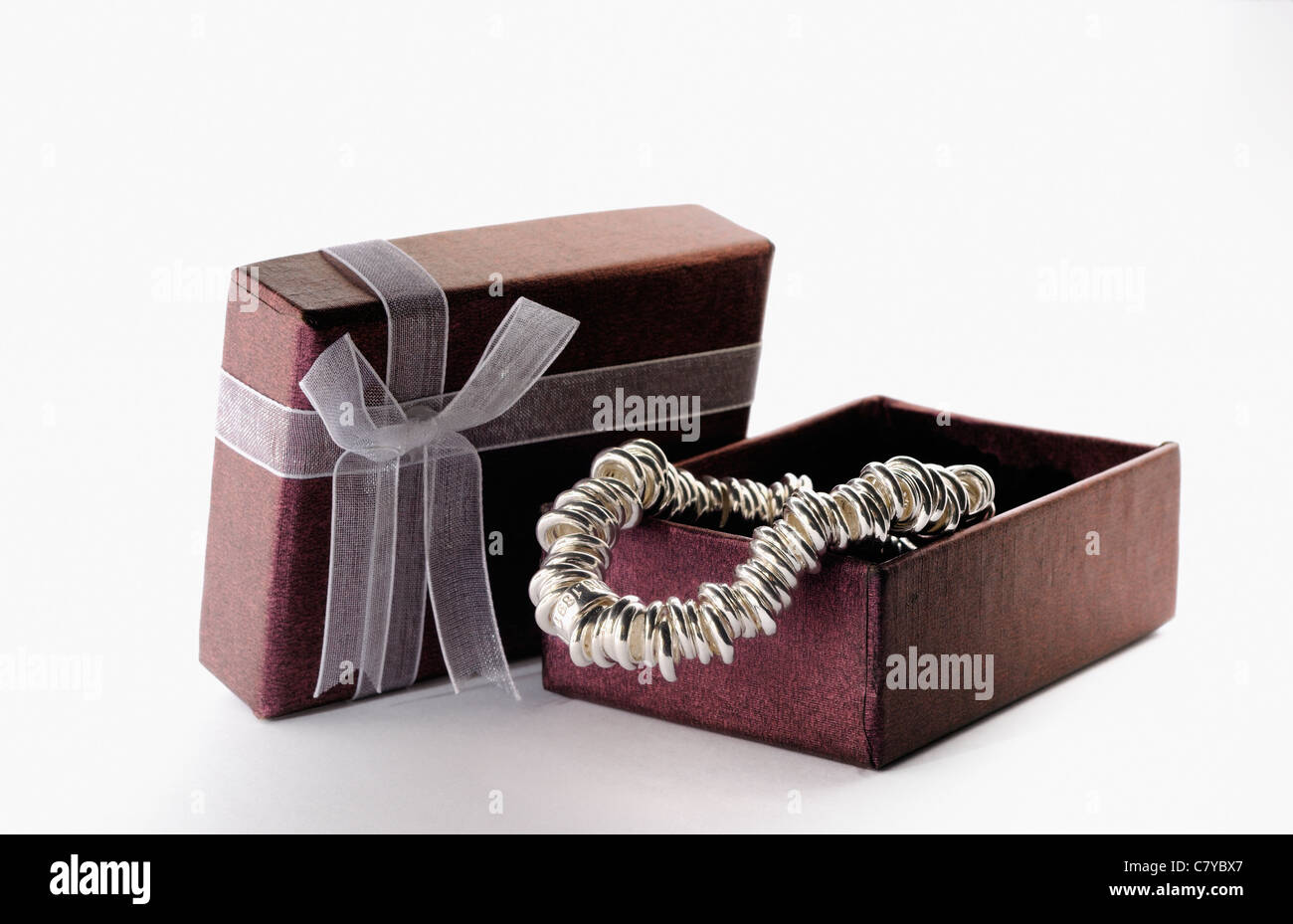 Silver bracelet in open gift box on white background Stock Photo - Alamy