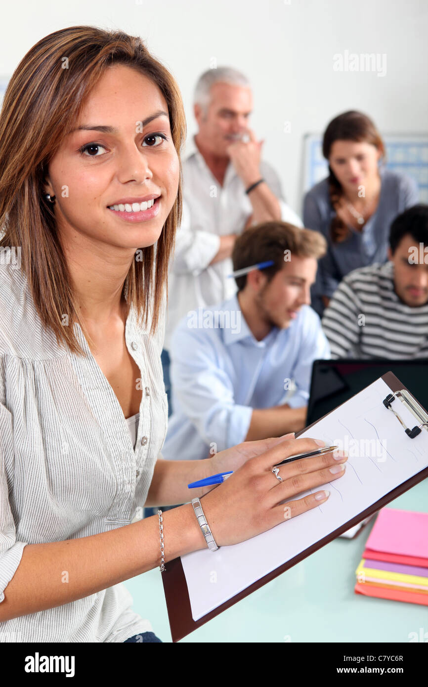 woman with notepad in classroom Stock Photo - Alamy